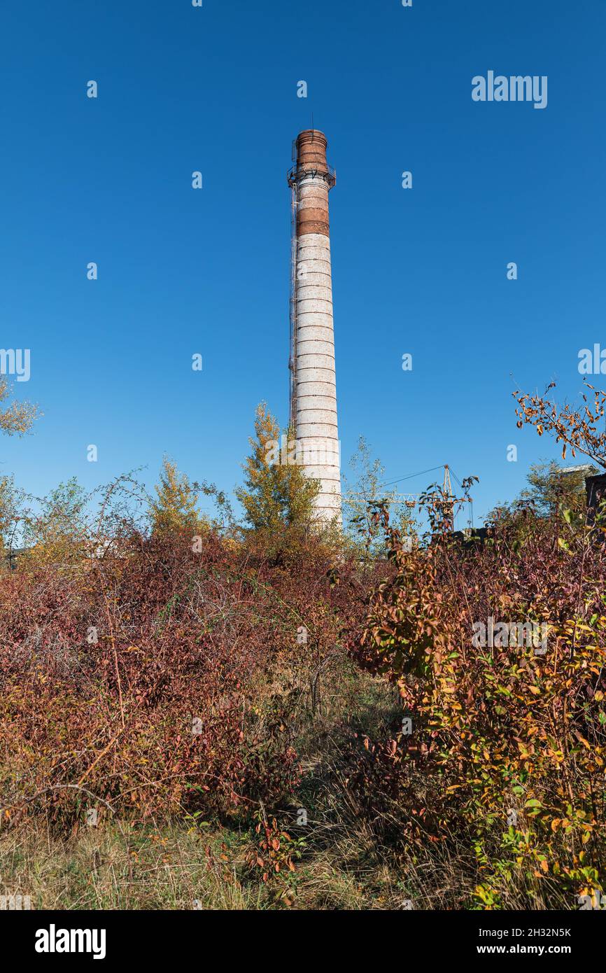 Large brick chimney. Tall factory chimney made of brick against blue ...
