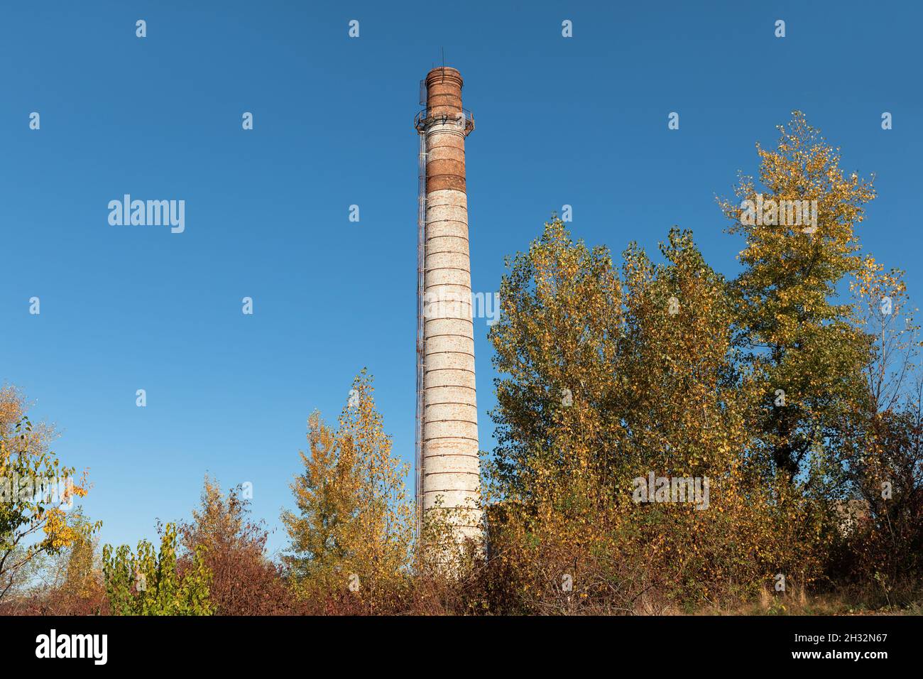 Large brick chimney. Tall factory chimney made of brick against blue ...