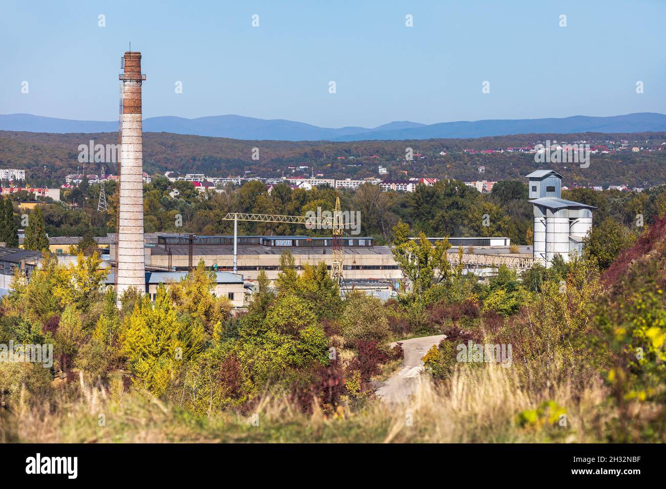 Large brick chimney. Tall factory chimney made of brick against blue ...