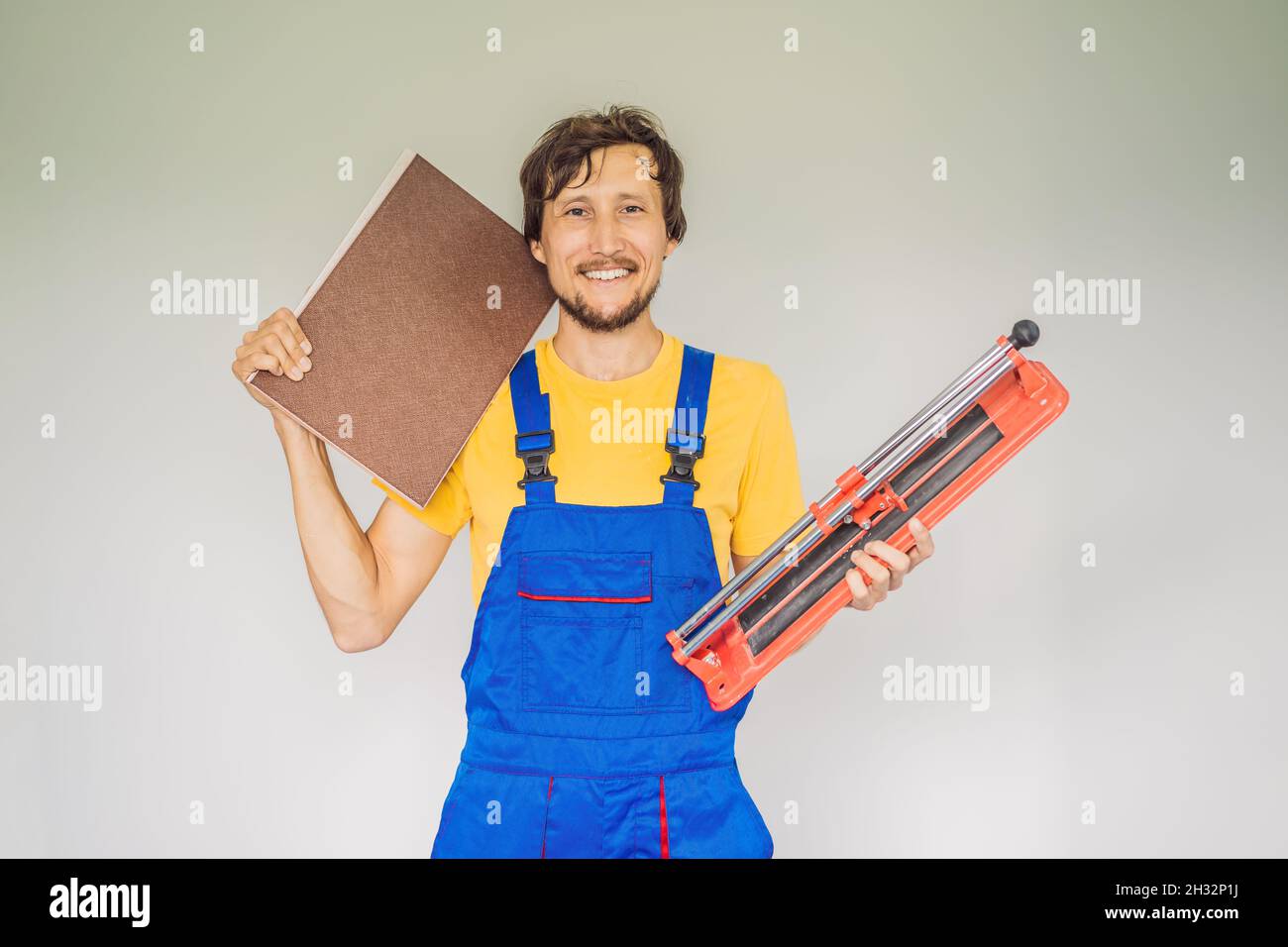 Hand holds tile cutter tool hi-res stock photography and images - Alamy