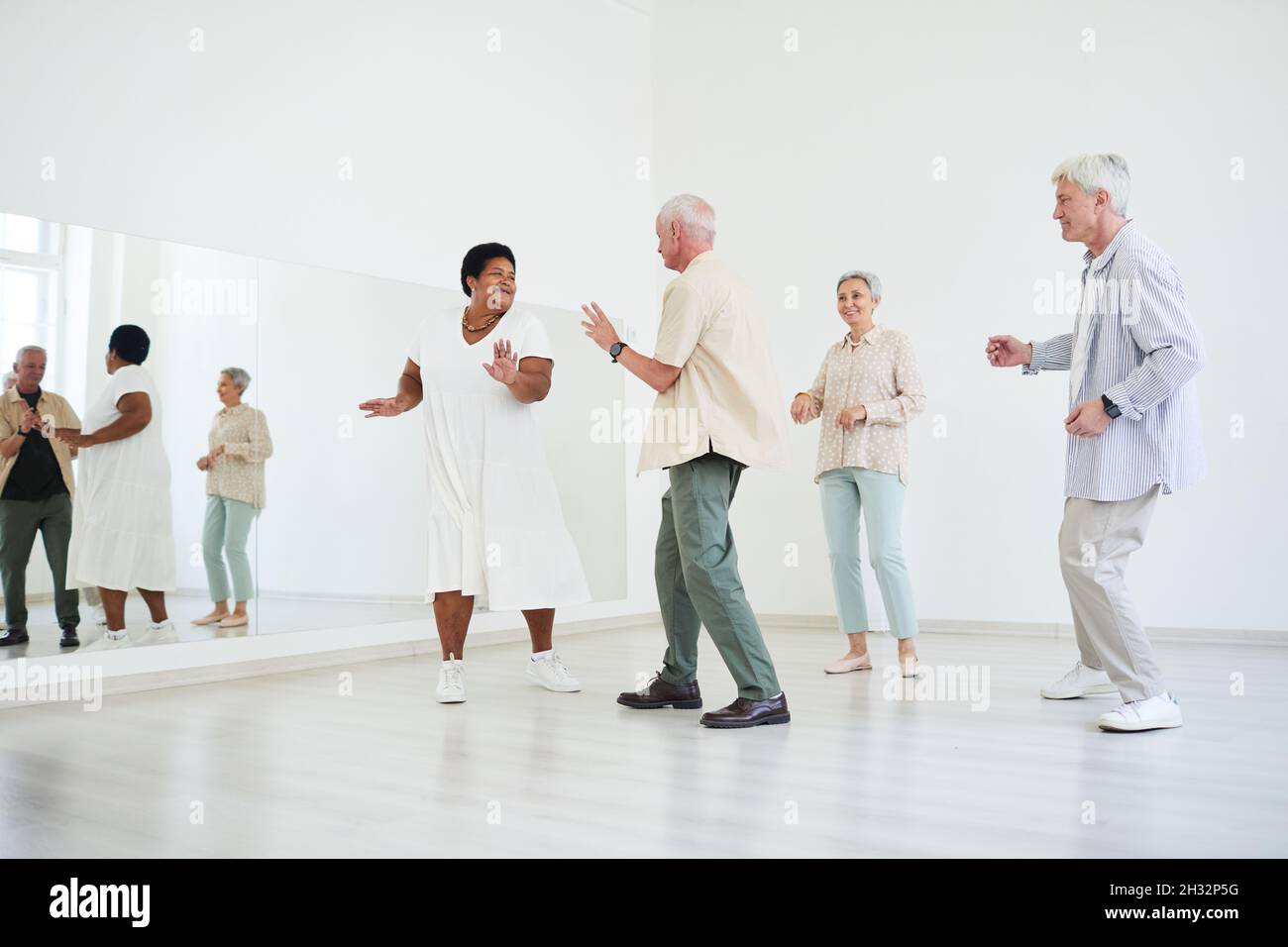 Group of senior people having a dance class, they dancing with each ...