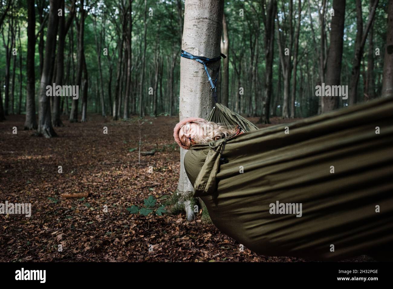 woman laying in a hammock in the forest sleeping Stock Photo - Alamy