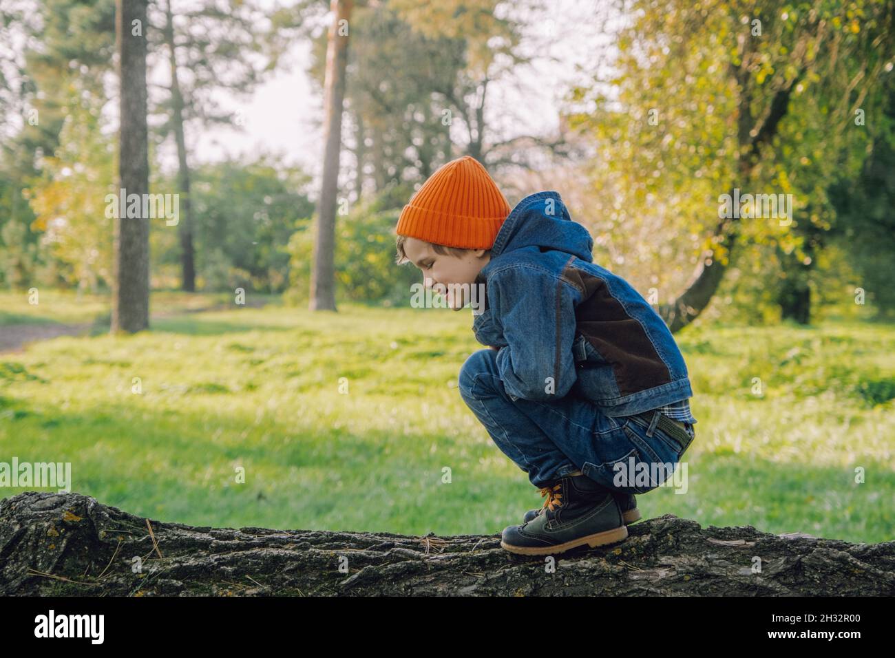 Little boy scout with spyglass during hiking in autumn forest. Child is ...