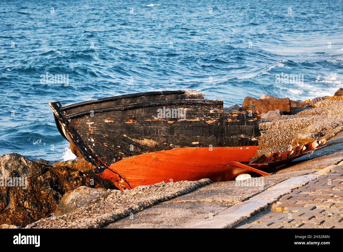 Old broken wooden fishing boat on the sea shore Stock Photo - Alamy