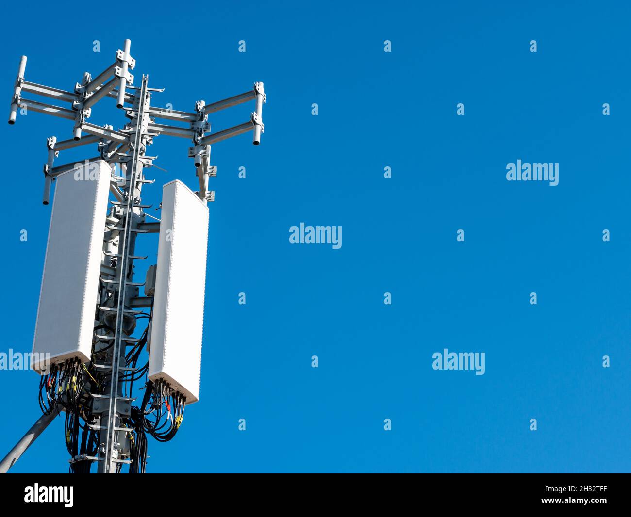 Telecommunications tower, 5g antenna and blue sky as background ...