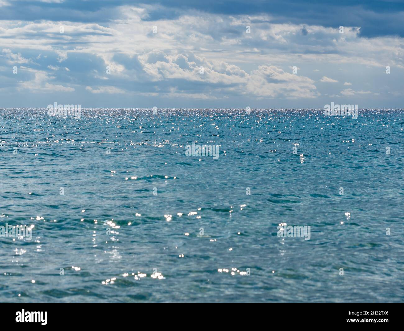 blue sea horizon sparkling in the rays of the morning sun with soft ...