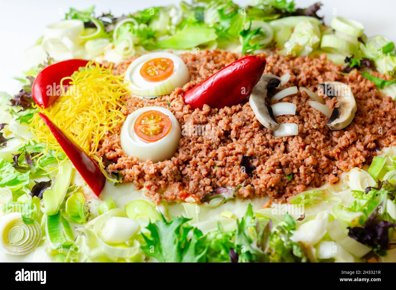 Minced meat formed in the shape of a face of the devil, a creative way ...