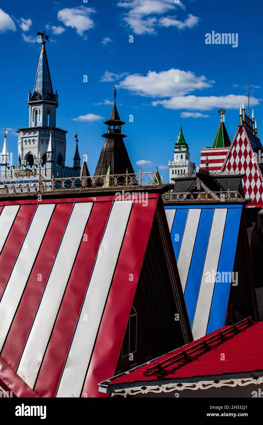 a cluster of roofs of different styles and shapes against a blue sky ...