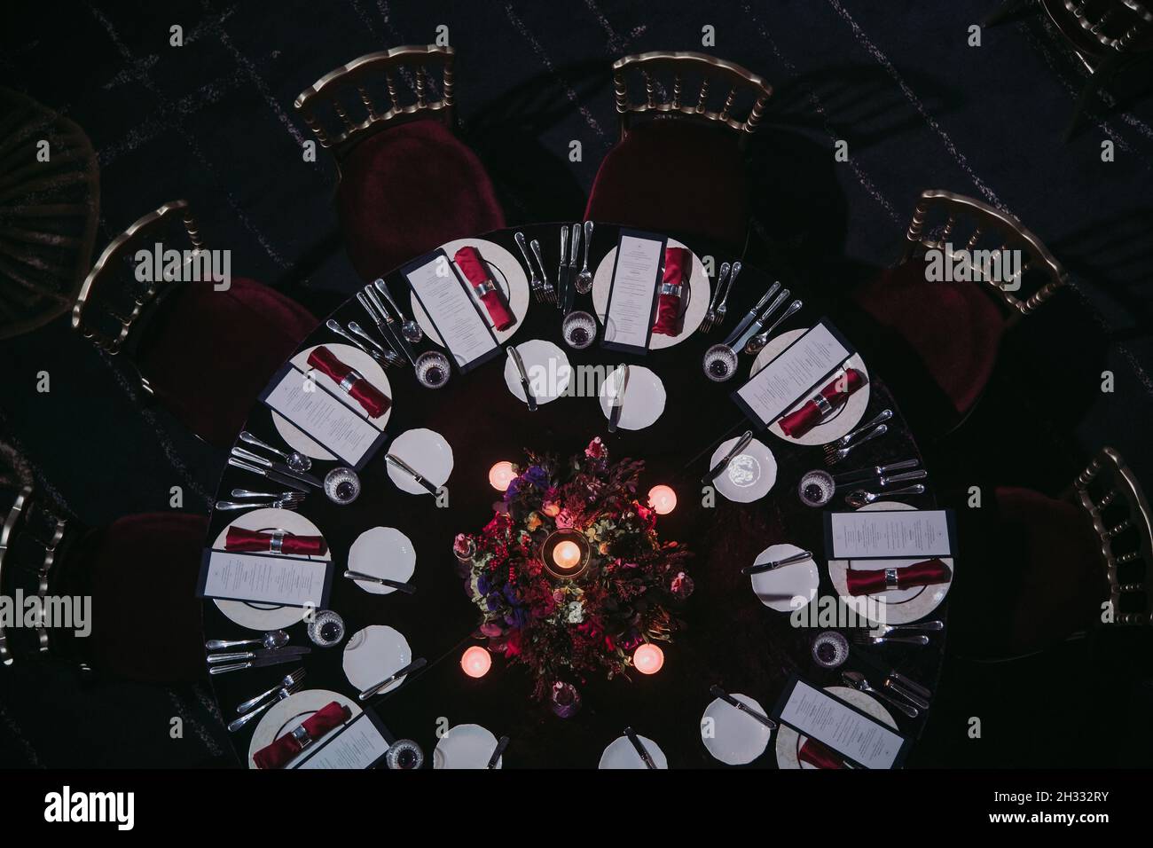 Dining table decorated with candles in the dark restaurant Stock Photo ...