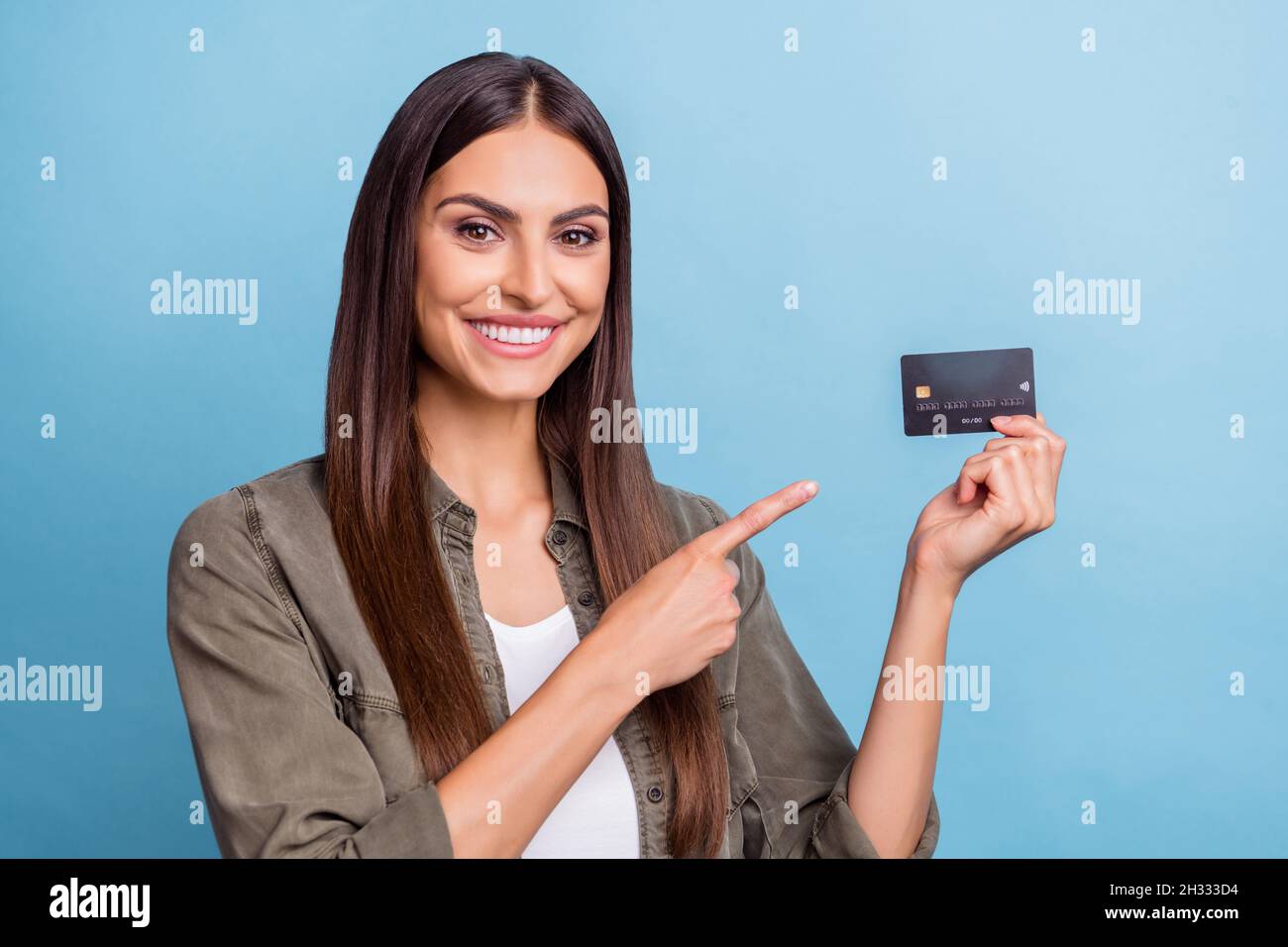 Photo of cute millennial brunette lady point card wear shirt isolated ...