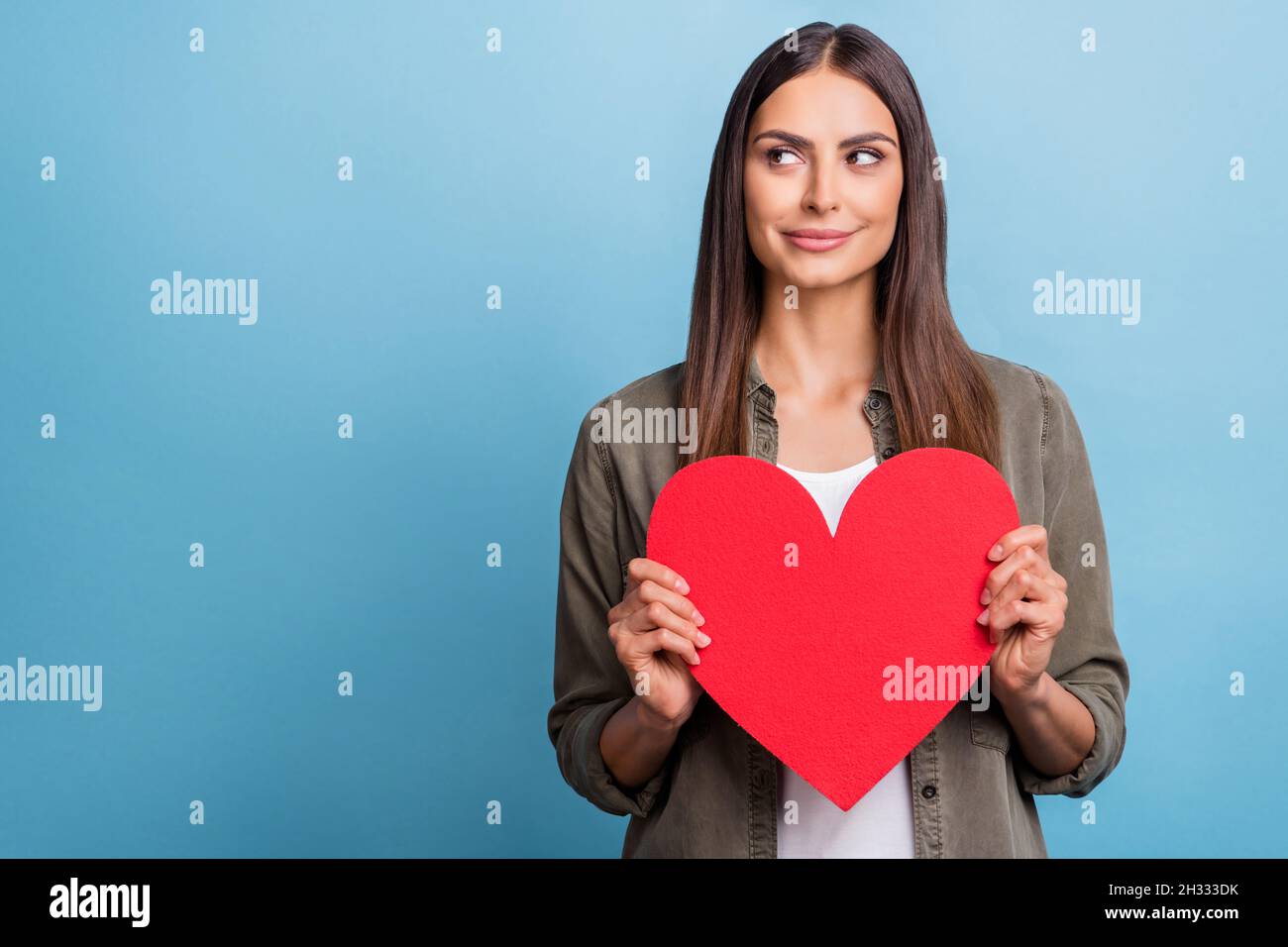 Photo of nice young brunette lady hold heart look wear shirt isolated ...
