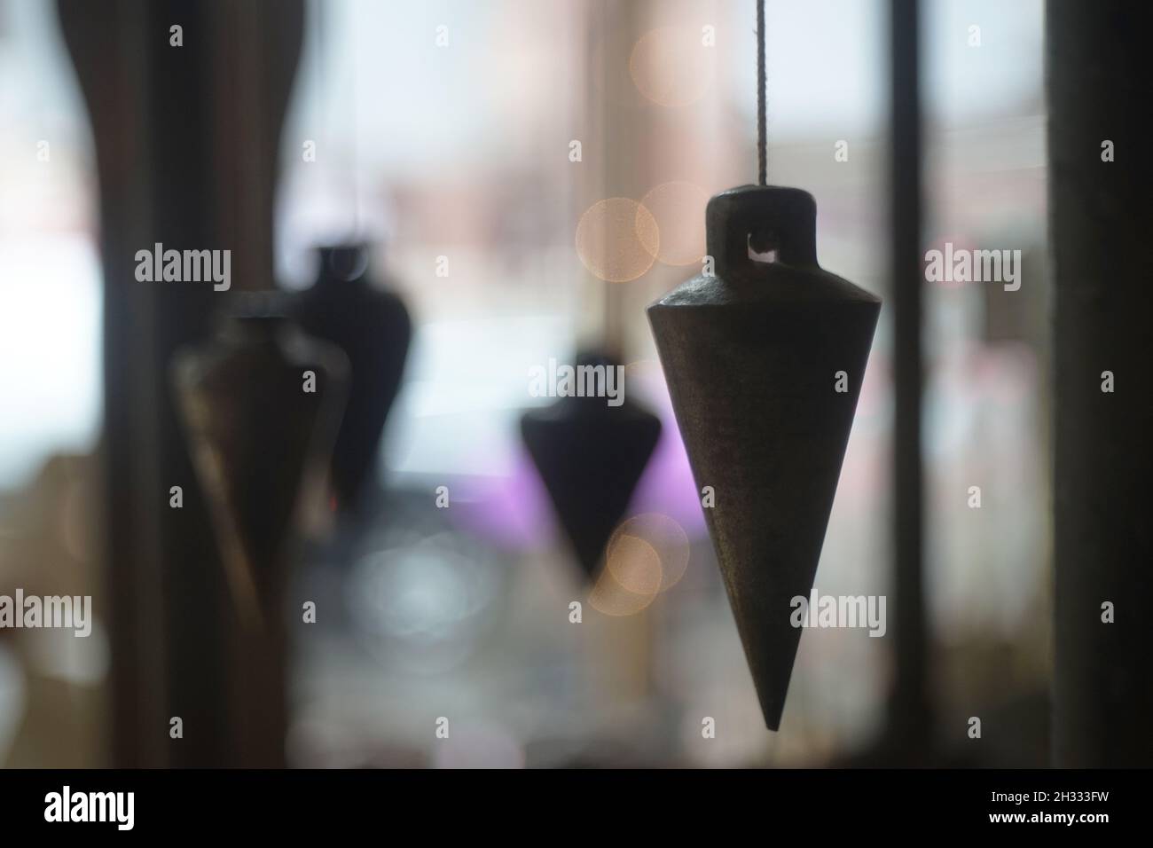 Plumb bob in the blurred background; leveling string weight toolsplumb ... Plumb bob in the blurred background; leveling string weight toolsplumb ...