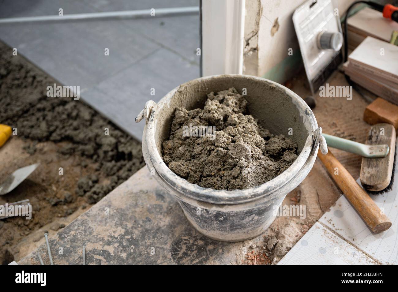 Cement in can with tools preparation for install tile Stock Photo - Alamy