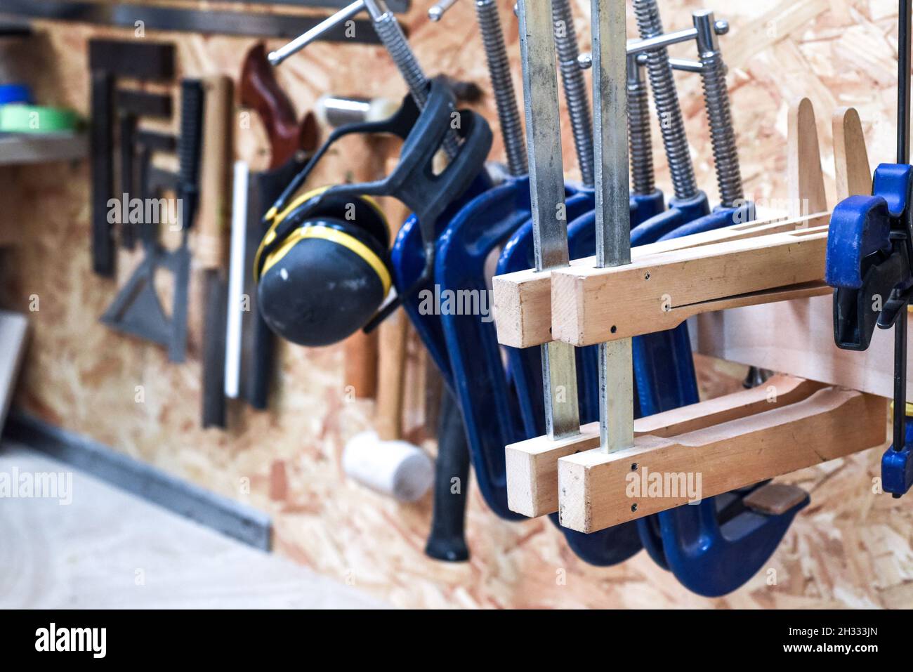 Work tools A selection of carpentry tools hang in a workshop for ...