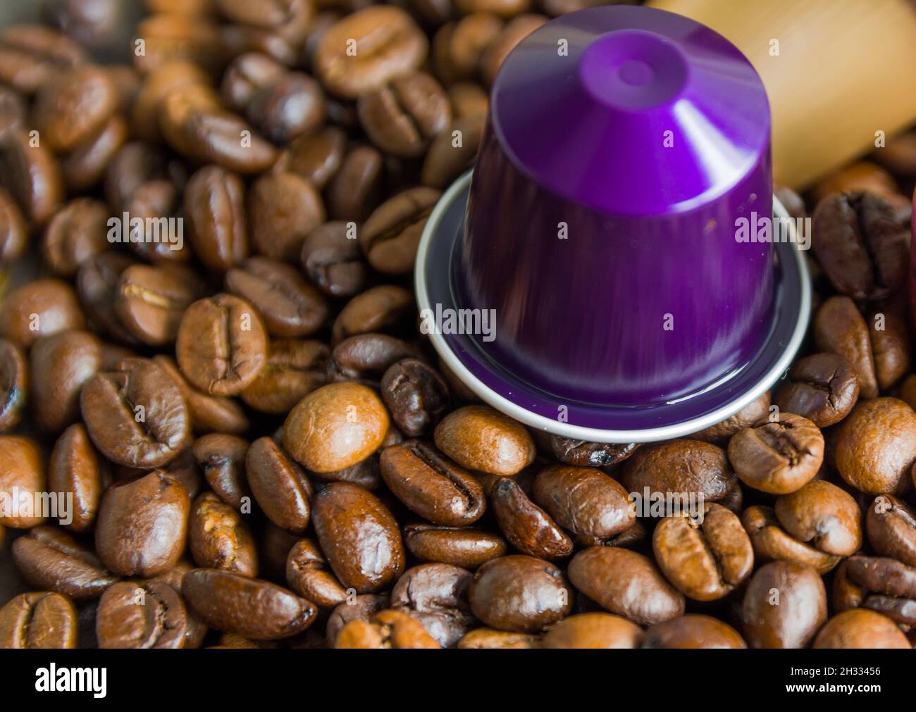 Beautiful colored coffee capsule on coffe beans background Stock Photo ...