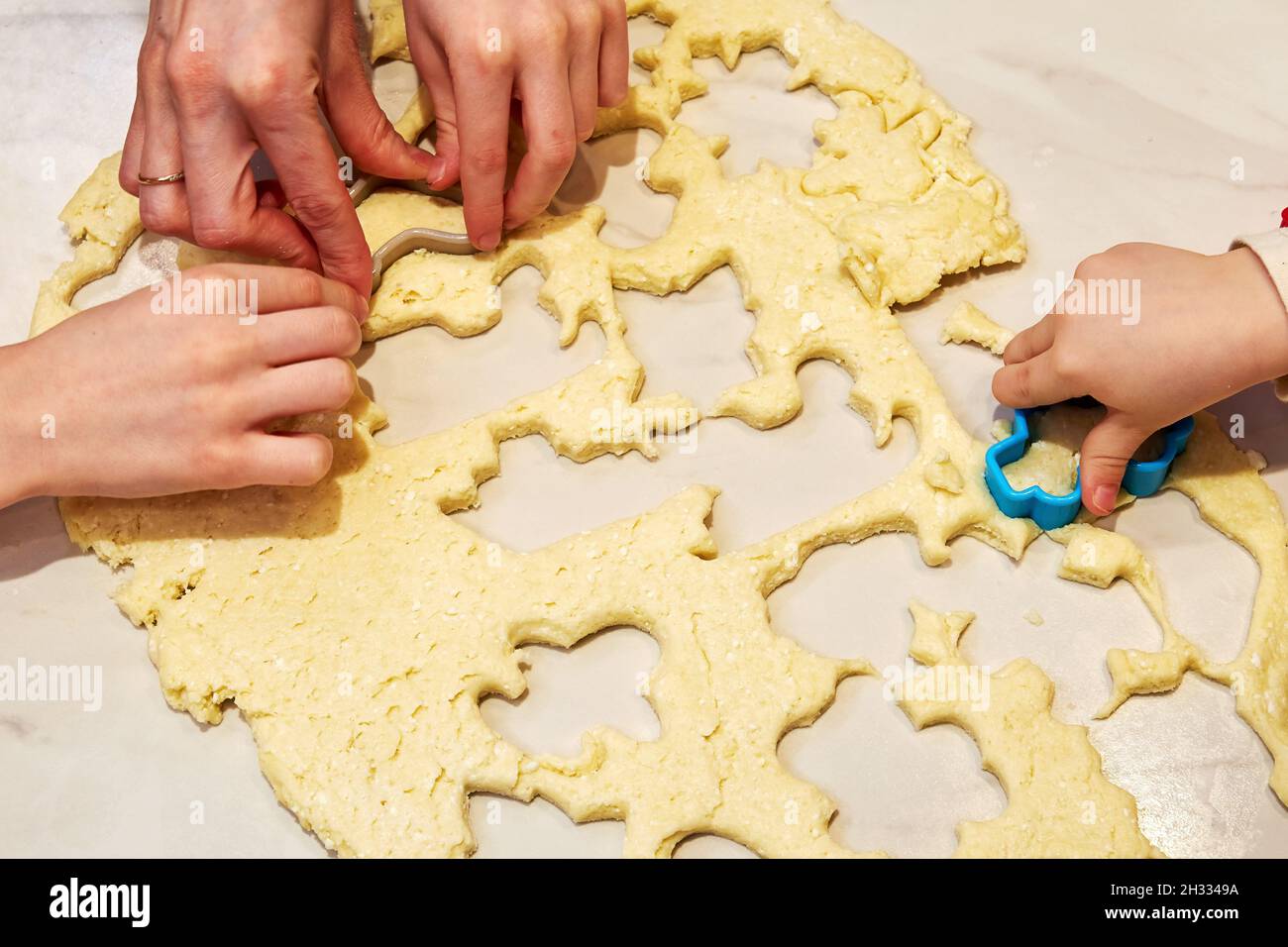 Parents and kids cook sweet cookies in the kitchen together. Family ...