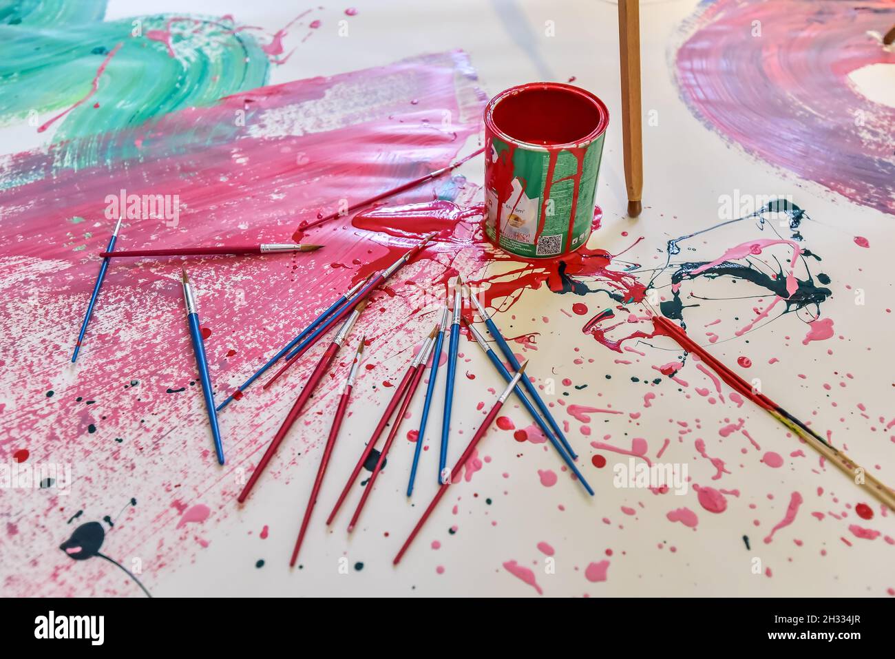 Closeup shot of the creative mess with the color jar and paint brushes ...