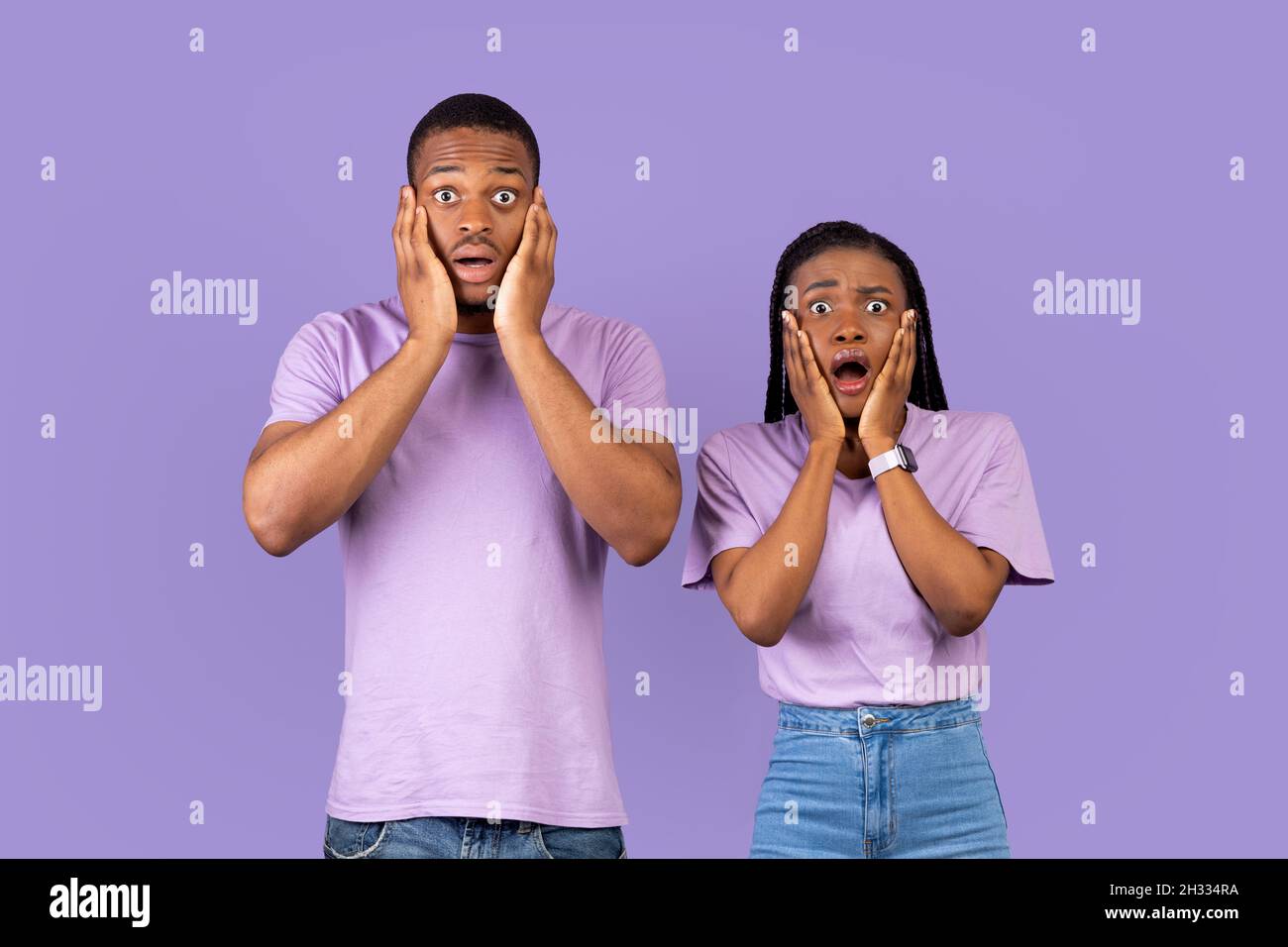 Omg. Portrait of scared African American couple touching face and ...