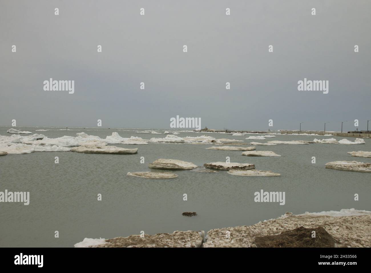 View of an icy beach with ice blocks in the water and frozen sand Stock ...