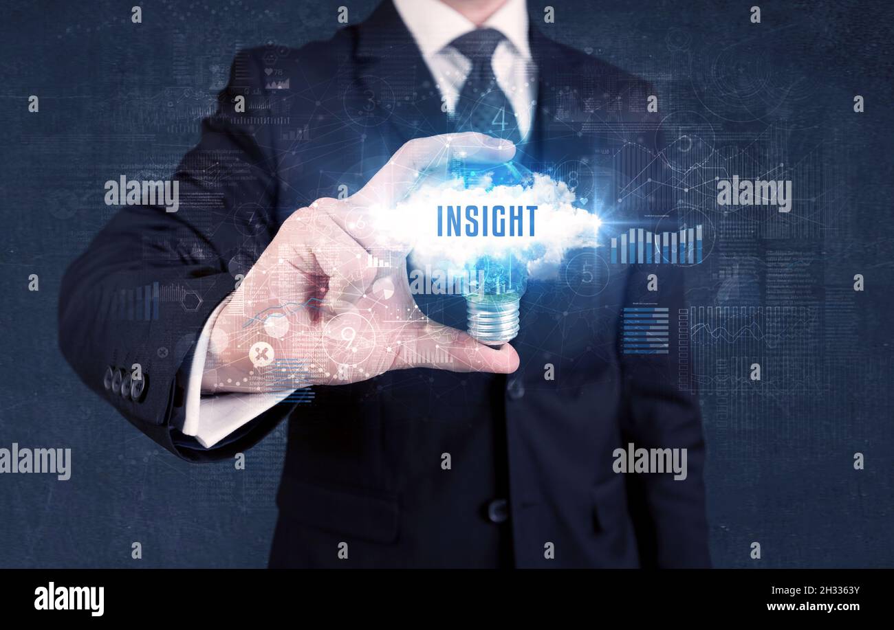 Businessman holding a light bulb, business concept Stock Photo - Alamy