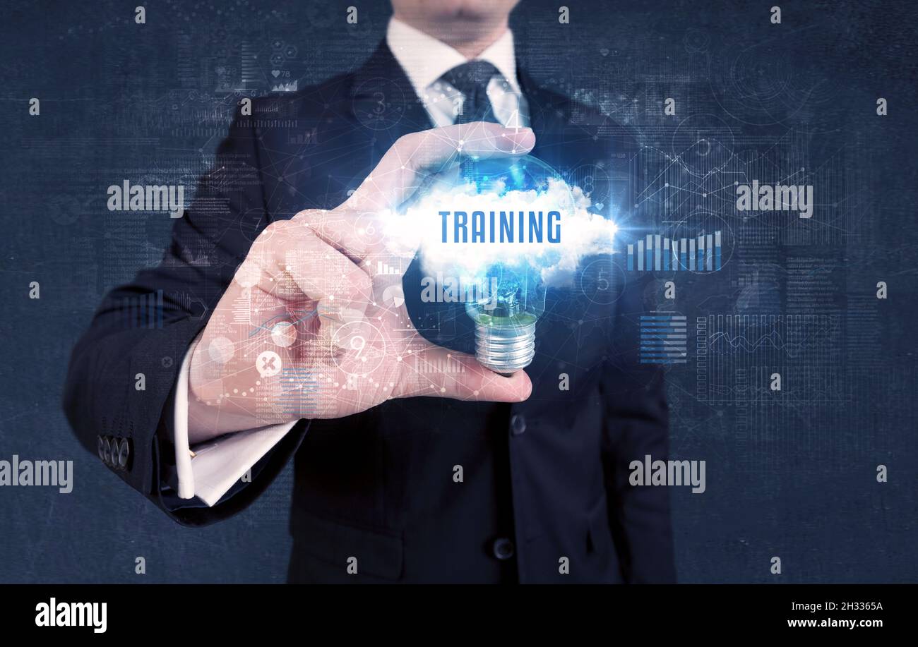 Businessman holding a light bulb, business concept Stock Photo - Alamy