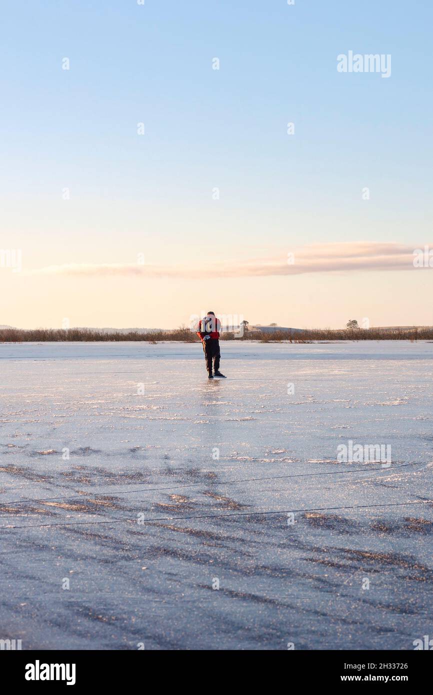 Long distance ice skating on natural ice Stock Photo - Alamy