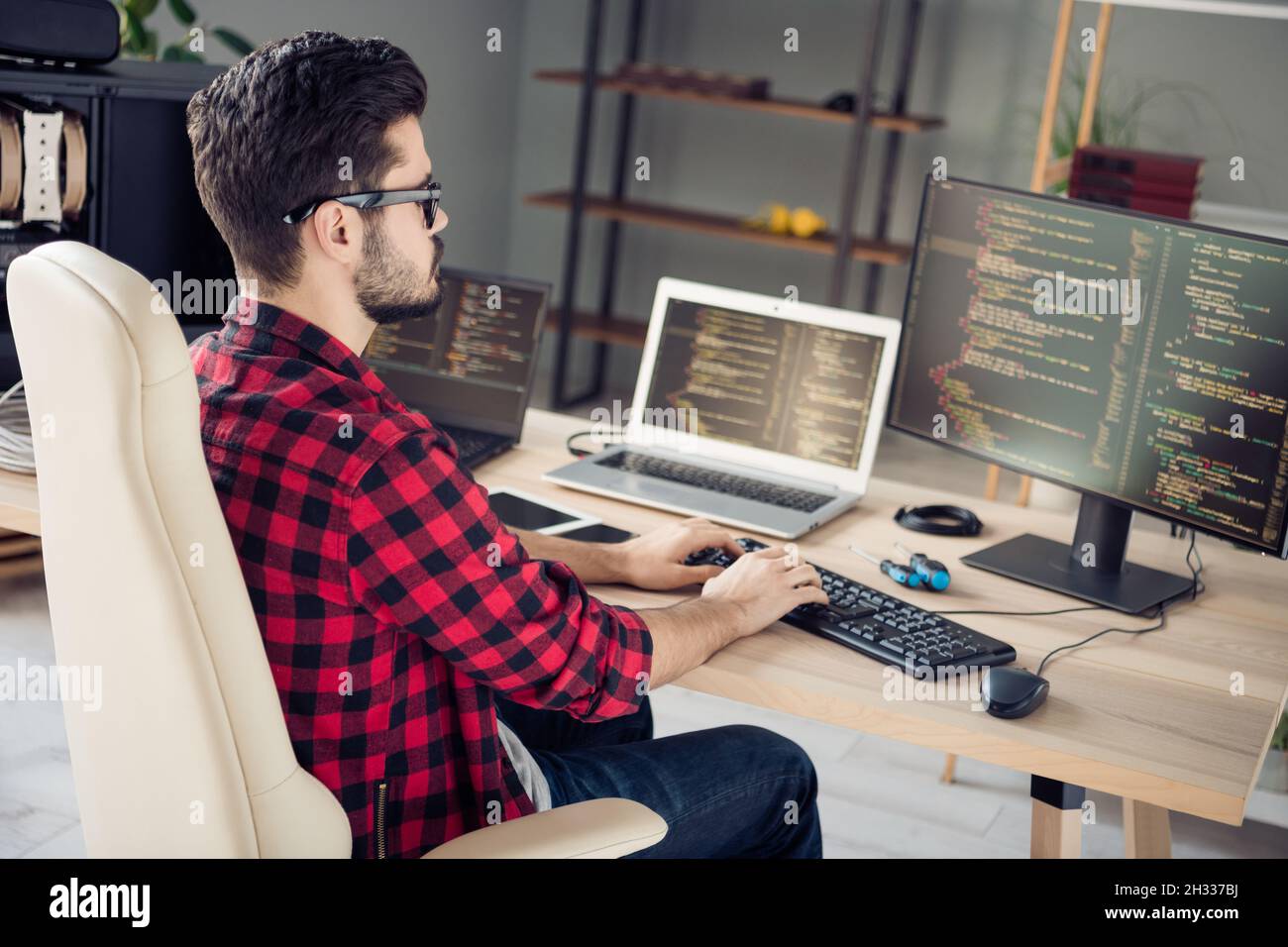Profile side view portrait of attractive focused skilled guy technician ...
