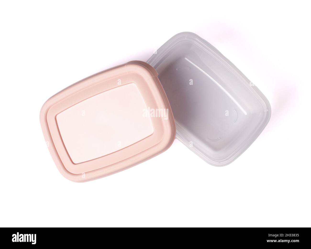 Open plastic food storage container with pink lid isolated on white ...
