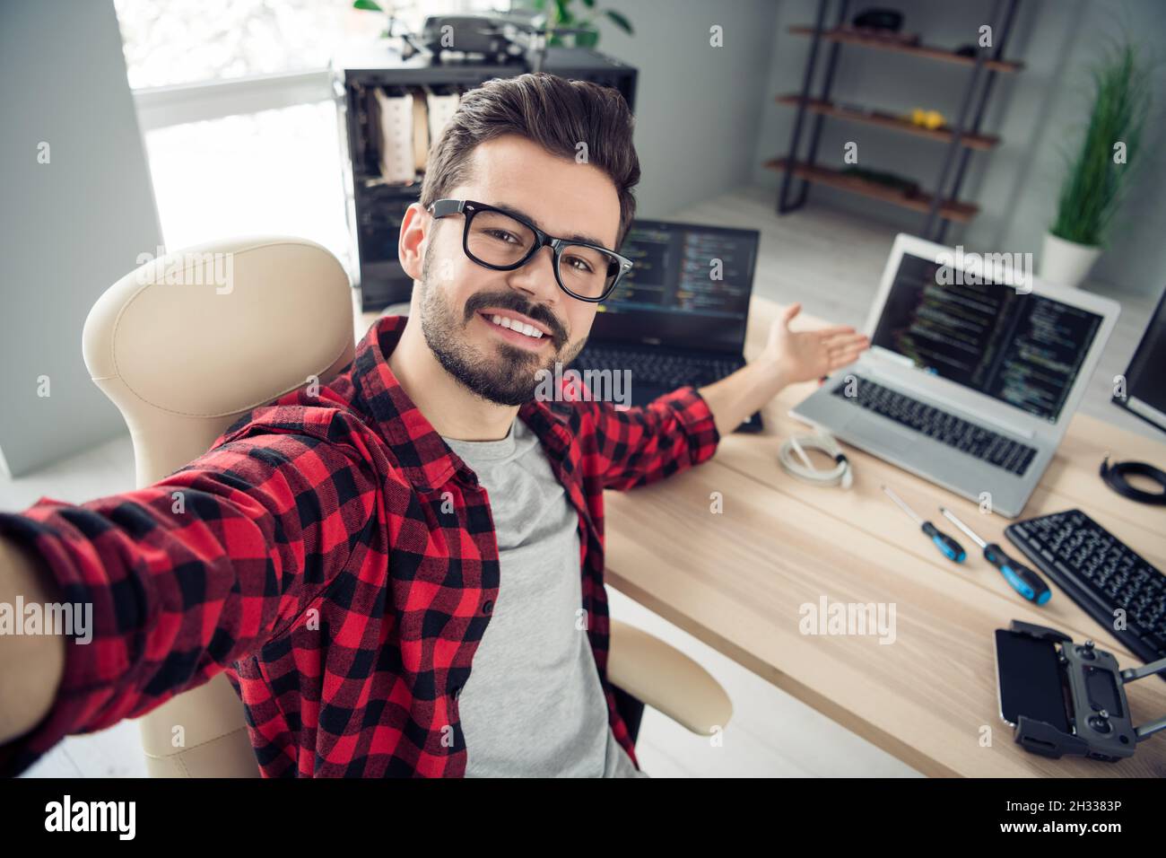 Self-portrait of attractive cheerful smart clever guy demonstrating web ...