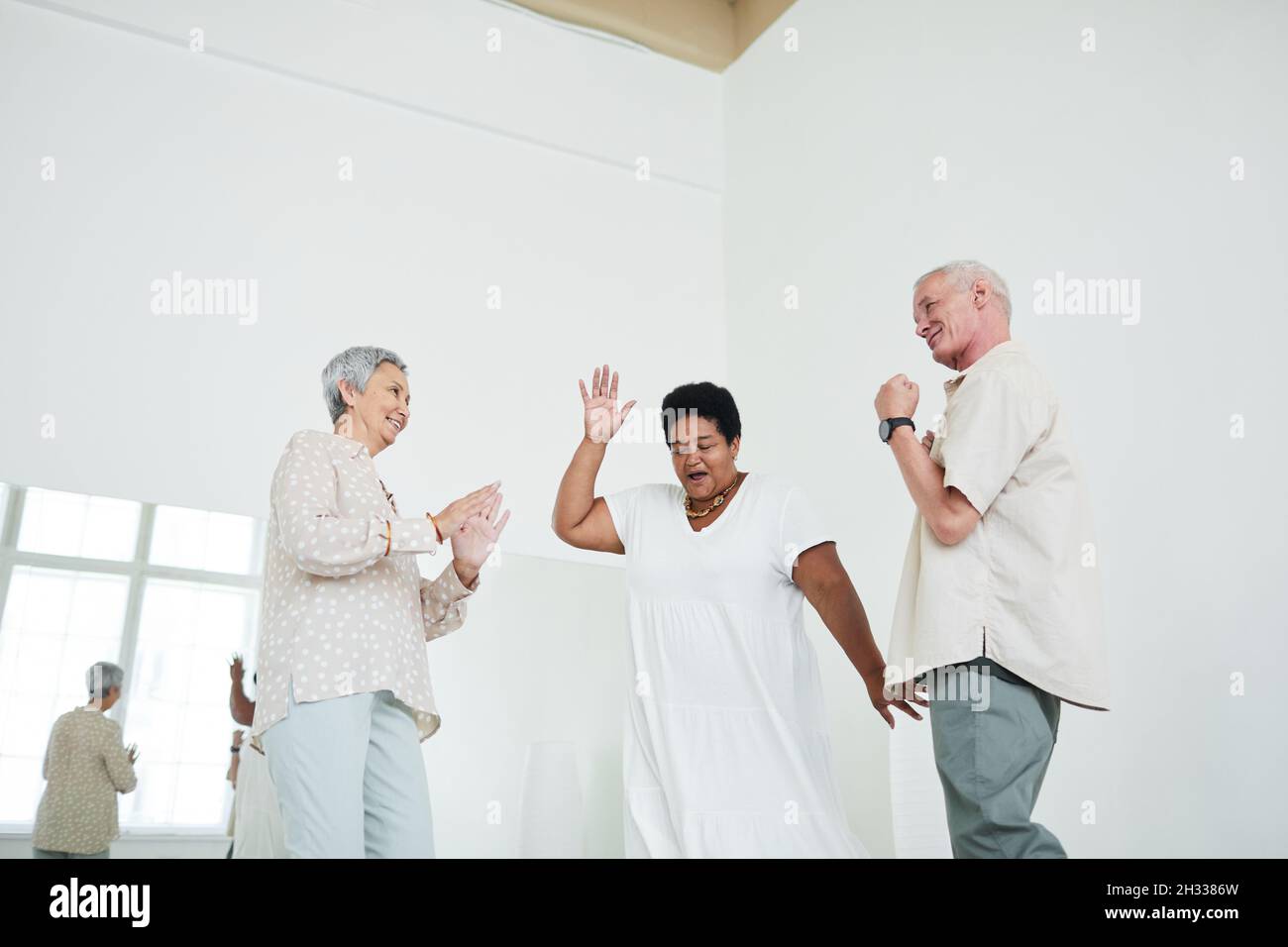 Senior people dancing to music during lesson in dance studio Stock ...
