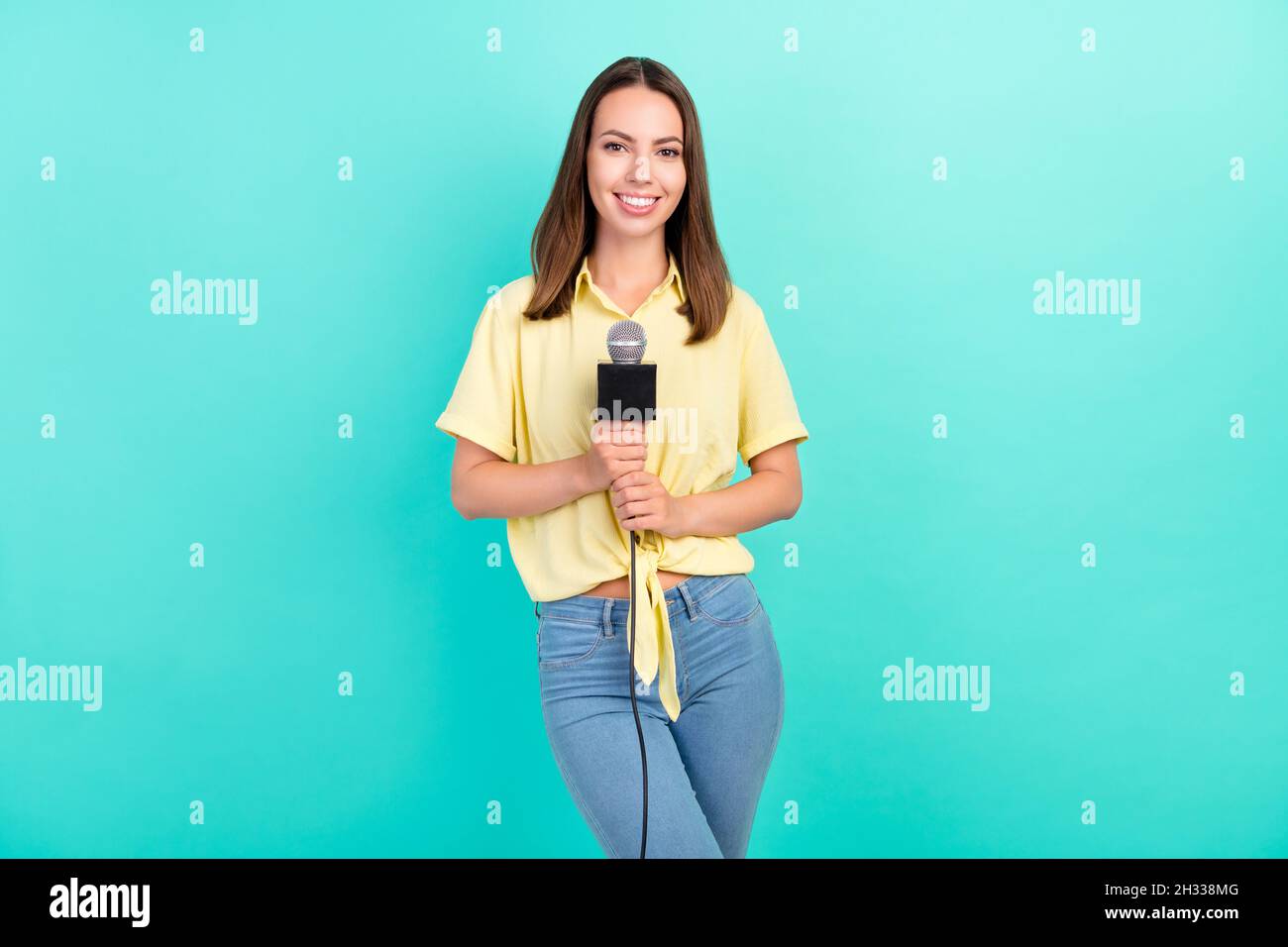 Photo of funny young brunette lady hold mic take interview wear yellow ...
