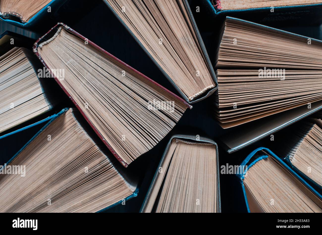 Parted books next to each other top view. Background from multicolored ...