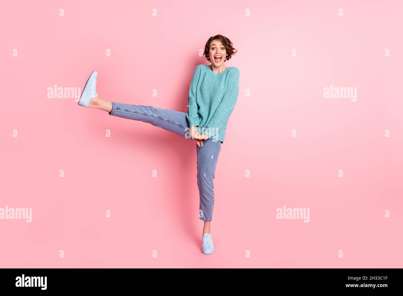 Full length photo of cheerful charming young lady raise leg funky mood ...