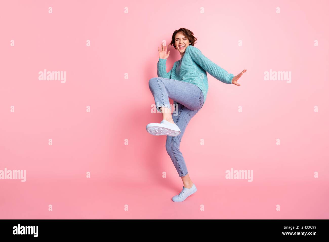 Full size portrait of cheerful satisfied lady toothy smile raise leg ...