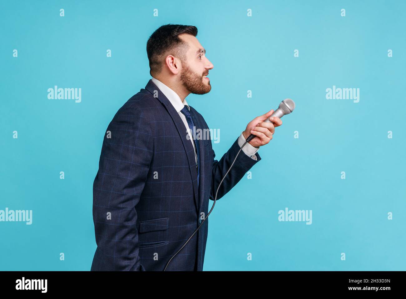 Side view portrait of bearded young adult man wearing official style ...