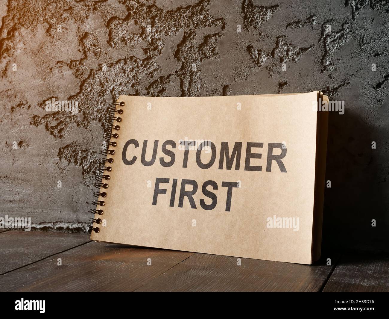 Customer first phrase on the notepad sheet Stock Photo - Alamy