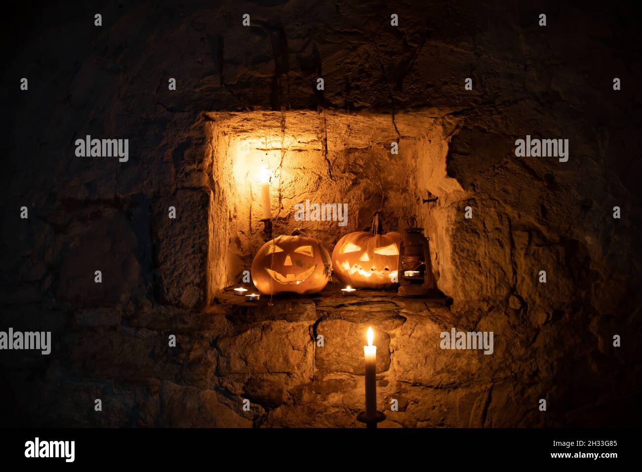 Jack O' Lantern glowing in old cellar in creepy fantasy night ...