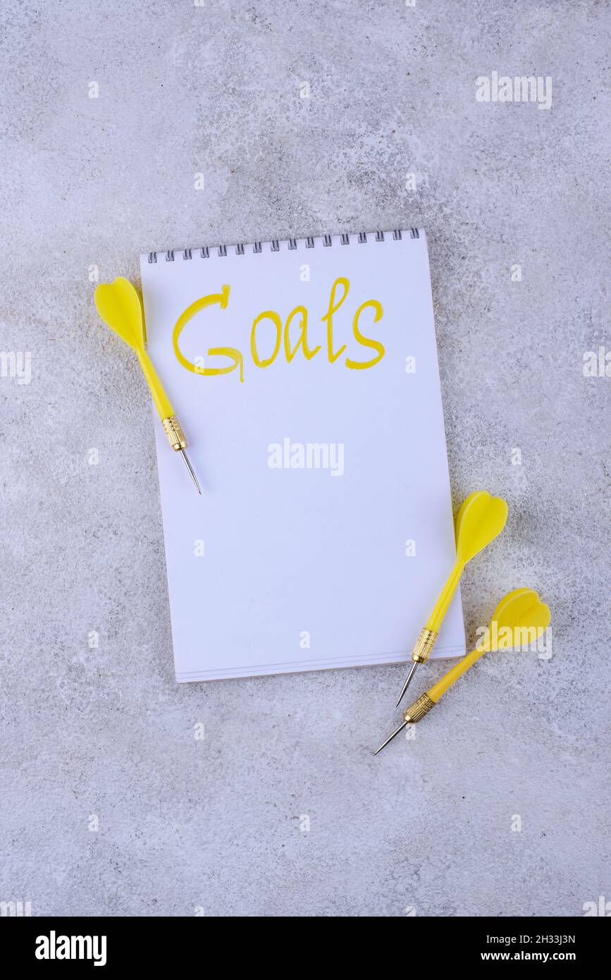 Target and goal concept with arrows and notebook Stock Photo - Alamy