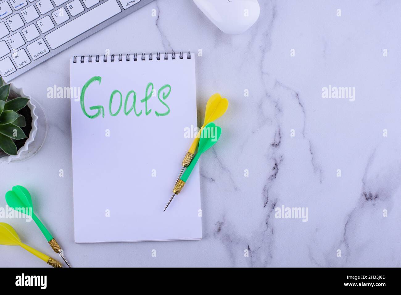 Target and goal concept with arrows and notebook Stock Photo - Alamy