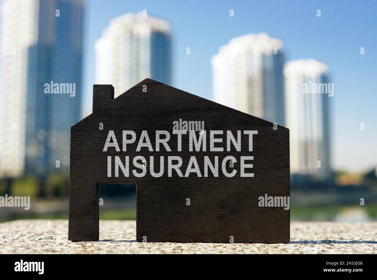 Apartment insurance concept. Model of home on the surface Stock Photo ...