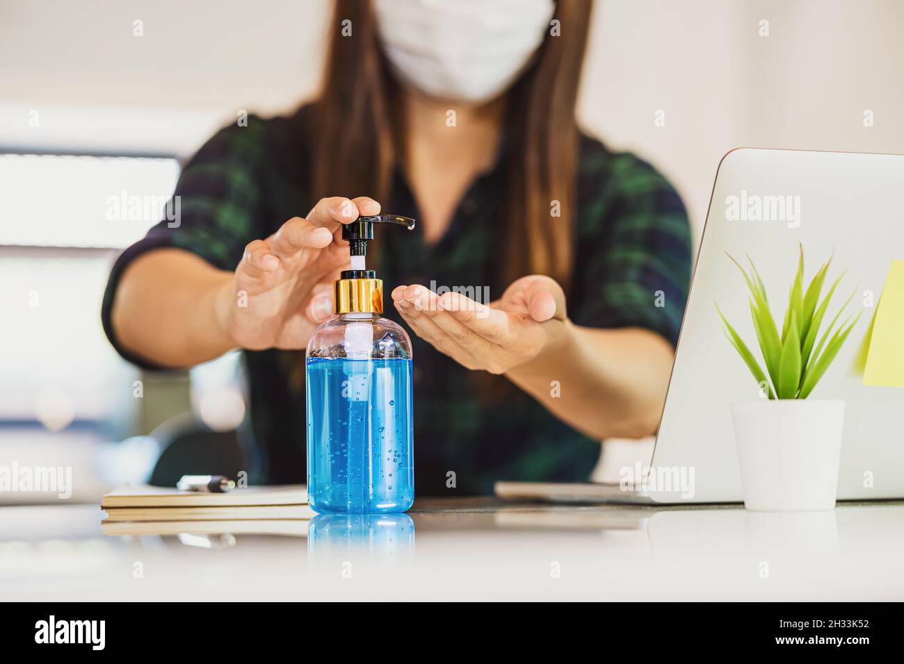 Closeup Asian woman hand using hand sanitizer when working at home with ...