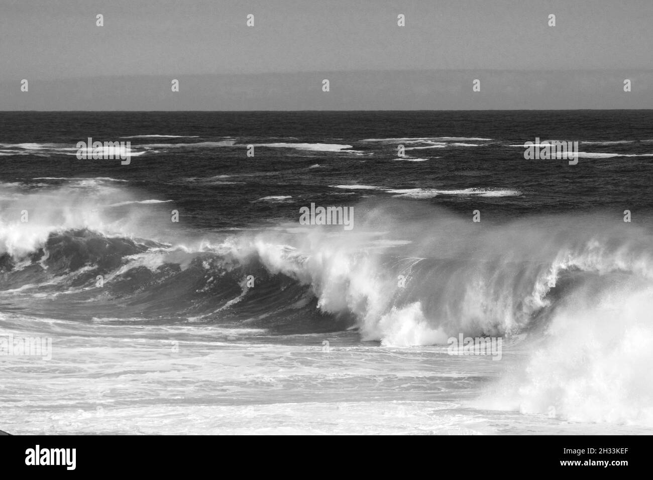 Black and White of a Wave breaking spectacular, forming a water tunnel ...
