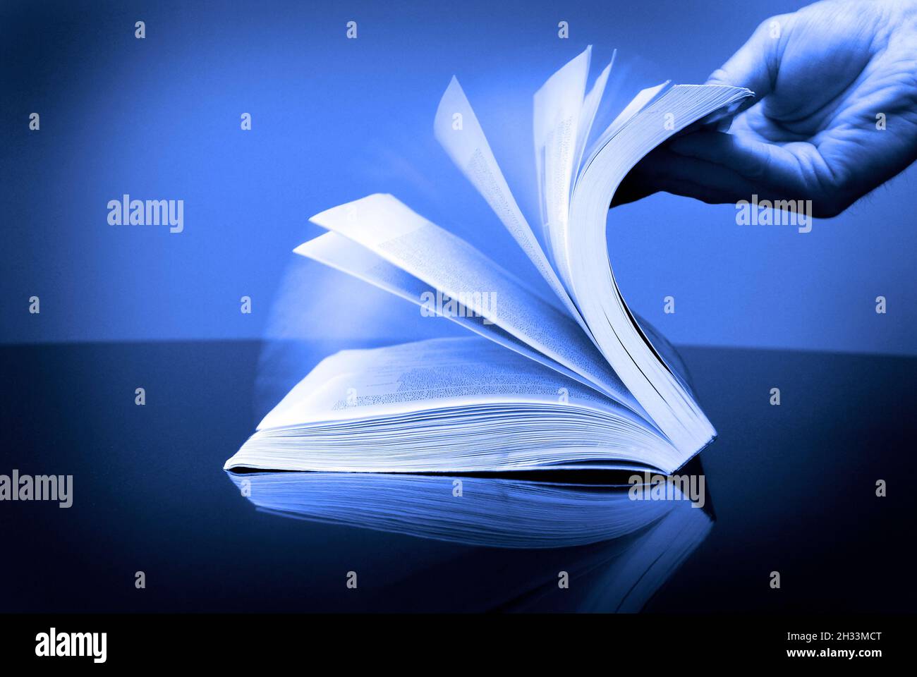Book for reading and hand flipping pages looking at information Stock ...