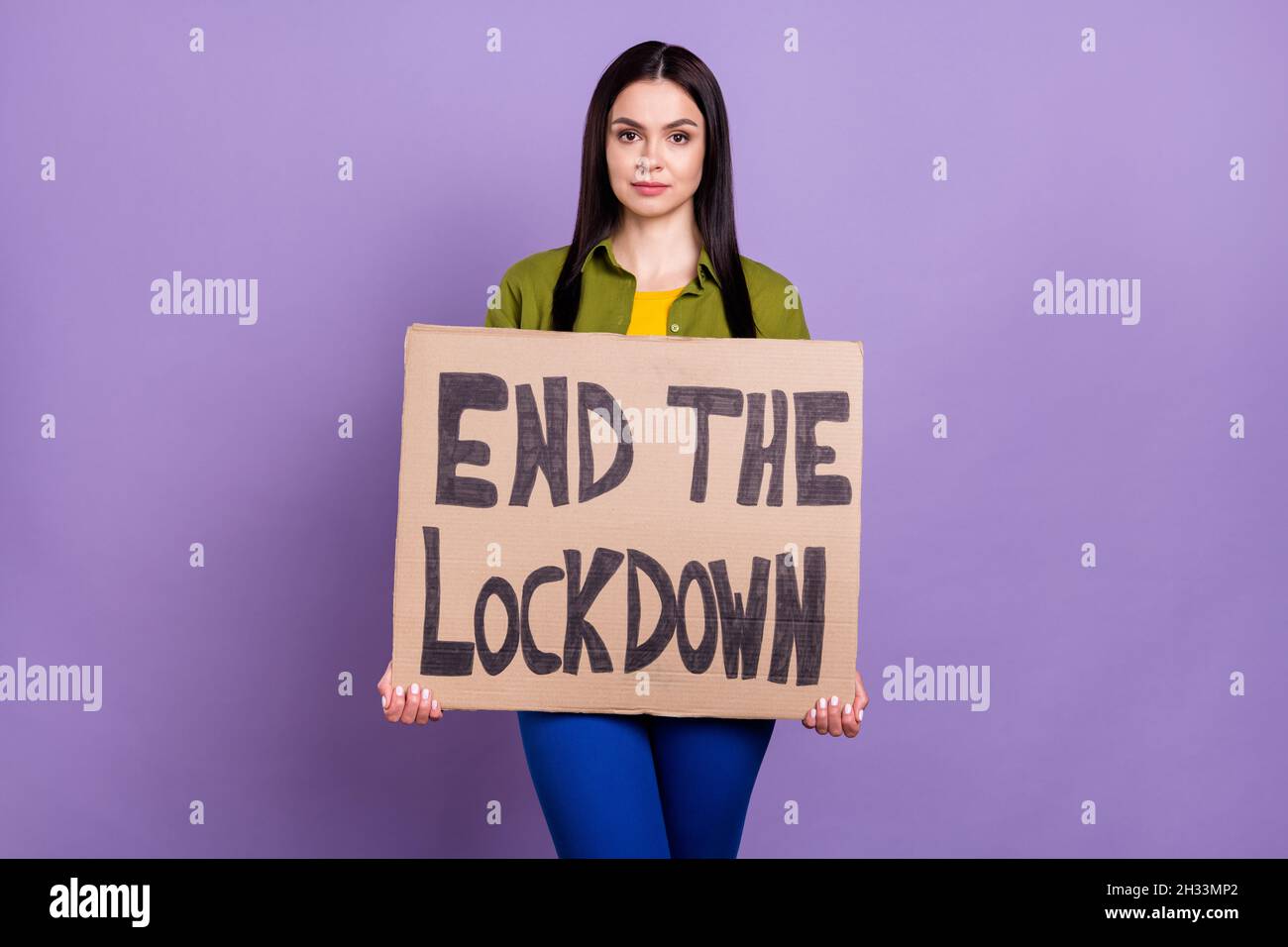 Photo of cute serious young woman wear khaki outfit holding the ...