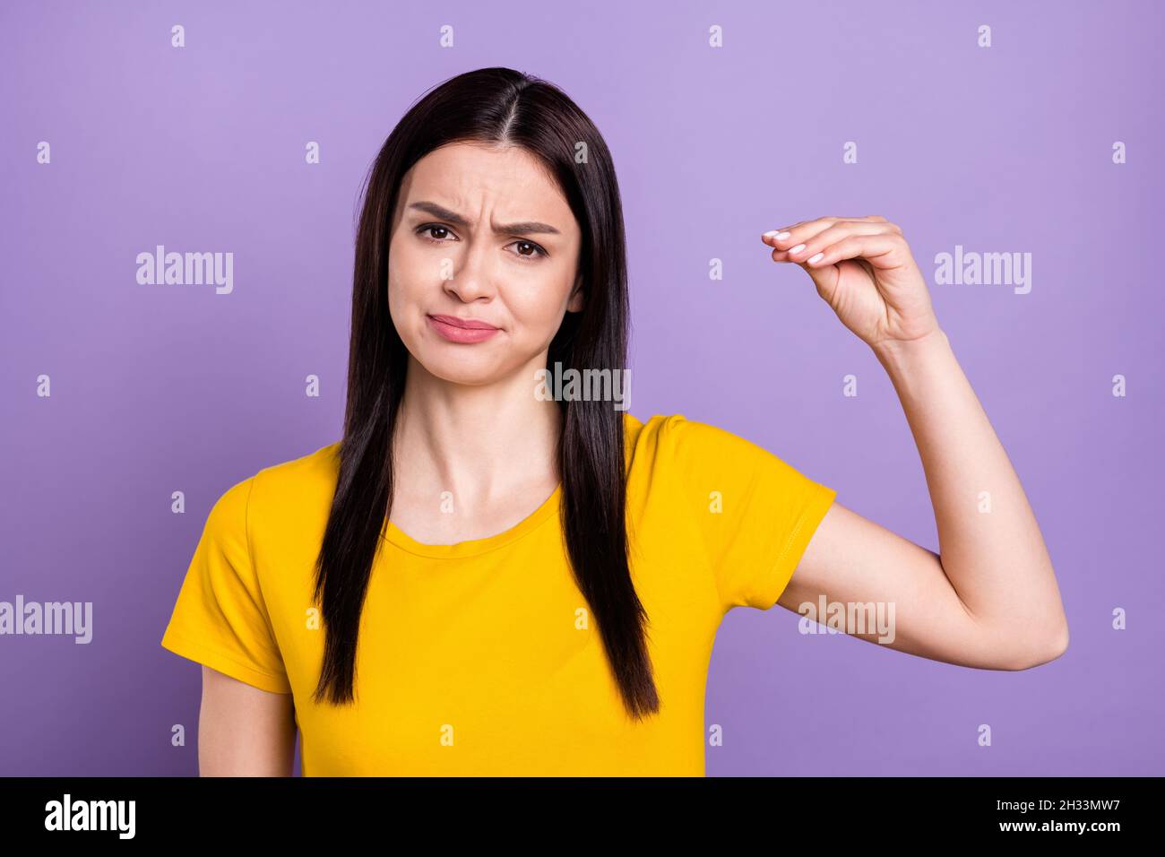 Photo of sad irritated young lady dressed yellow clothes showing blah ...