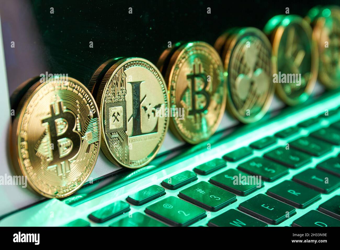 Close-up various golden cryptocurrency coins in a row Stock Photo - Alamy