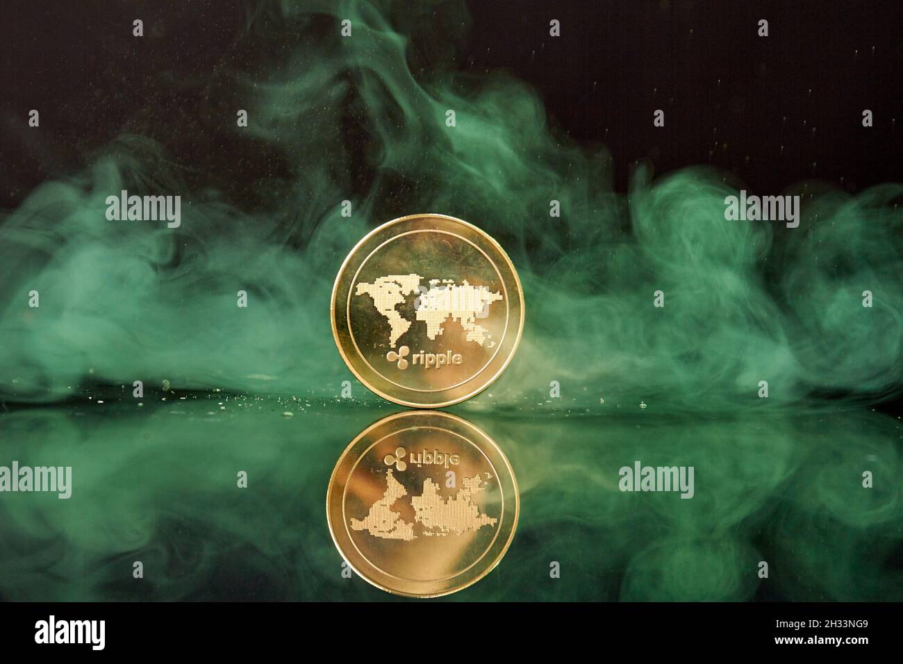 Standing golden ripple coin with smoke on reflective surface Stock ...