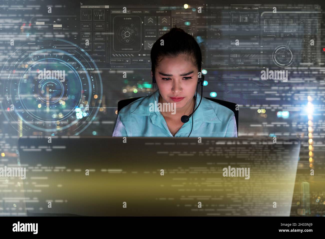 Asian Woman support desk working hard late at night over visual screen ...