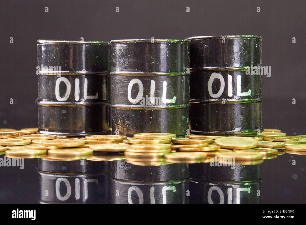 Barrels with oil and golden coins on the reflective desk Stock Photo ...