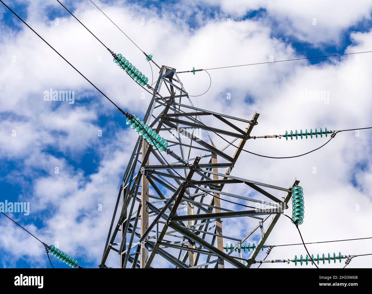 Close up of a transparent turquoise high voltage insulator or isolator ...